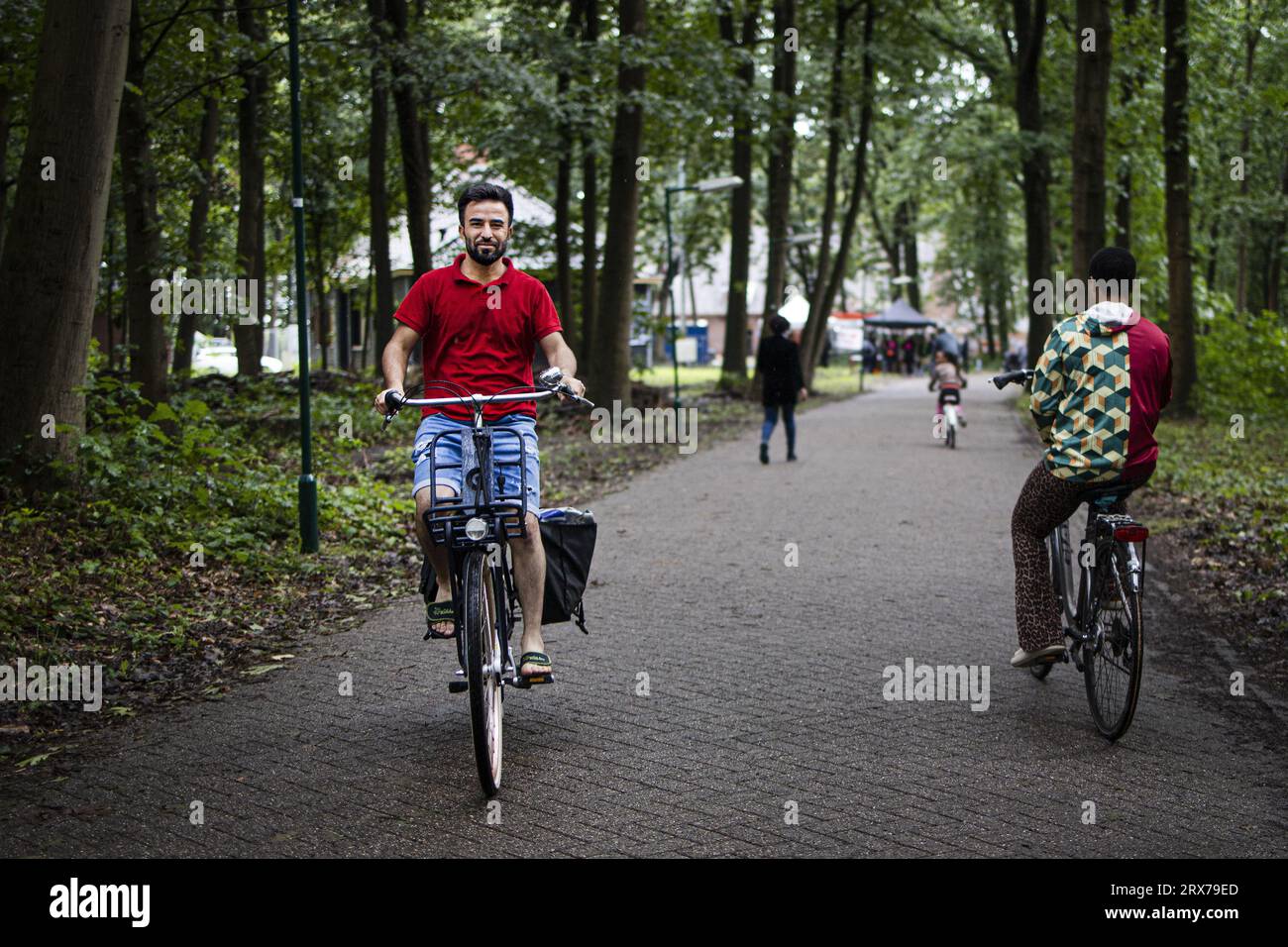 GILZE - Refugees on bicycles at the Gilze asylum seeker center on the ...