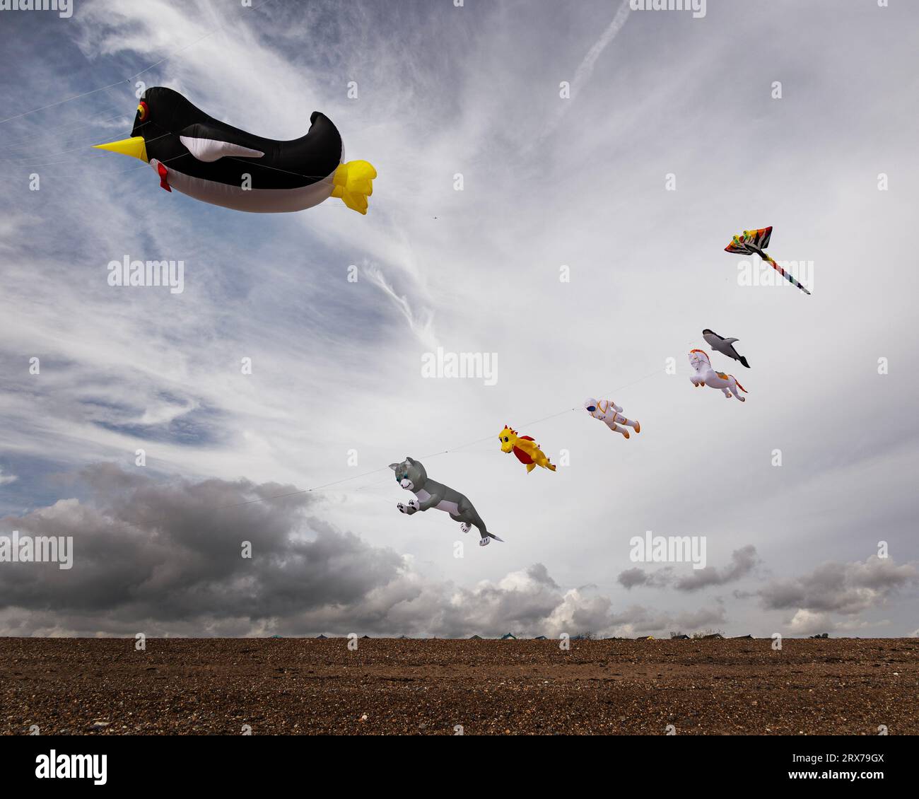 string of colourful kites being flown on Worthing beach, West Sussex ...