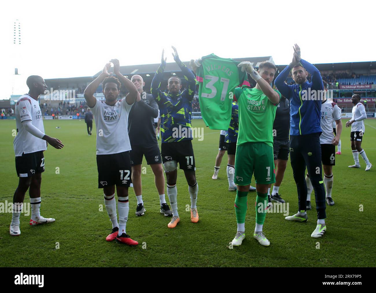Derby County goalkeeper Joe Wildsmith holds up a Josh Vickers strip in ...