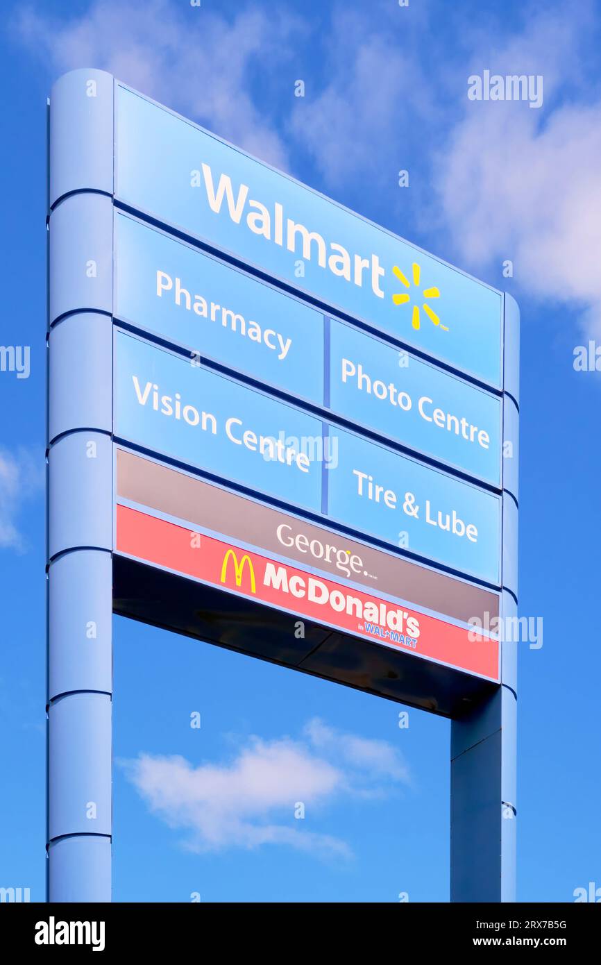 Sign roadside at a Walmart Supercentre listing services available ...