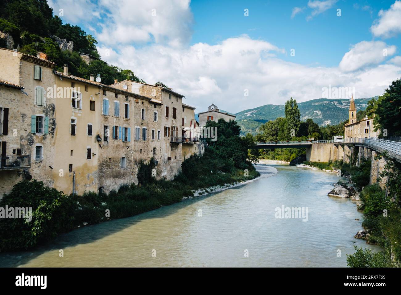 Overhanging houses facades over the Drome river in the medieval village ...