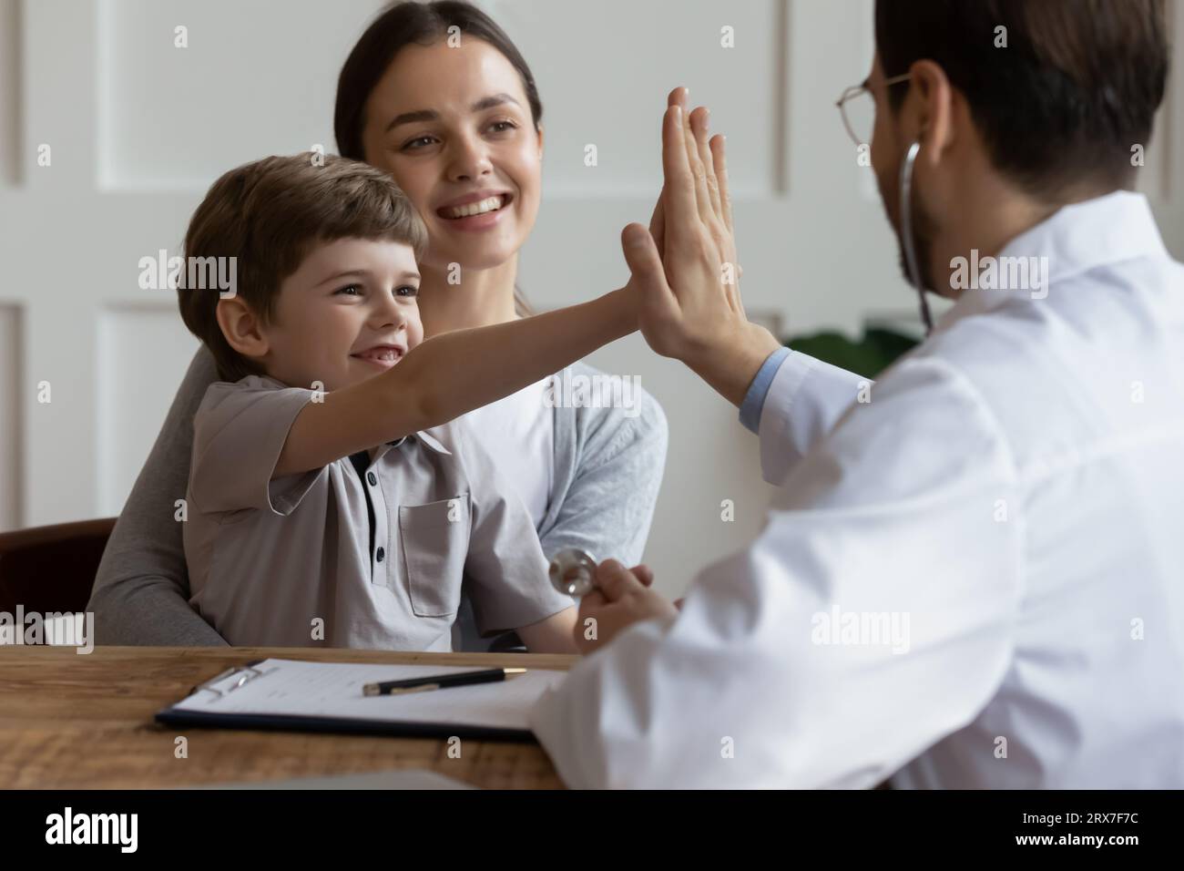 Friendly doctor giving high five to cute little patient Stock Photo - Alamy