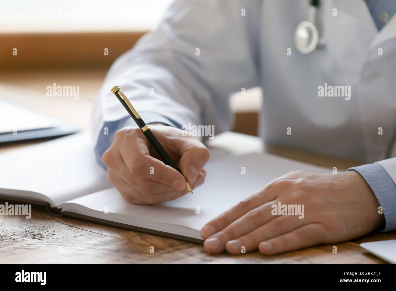 Doctor writing treatment plan patient hi-res stock photography and ...