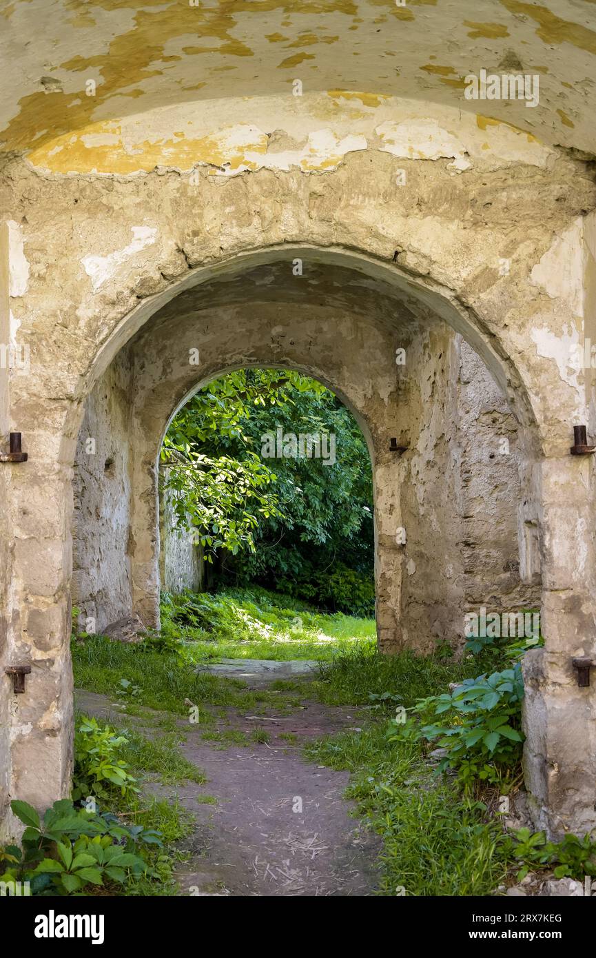 An unusual arched through passage into the rooms of an old ruined ...