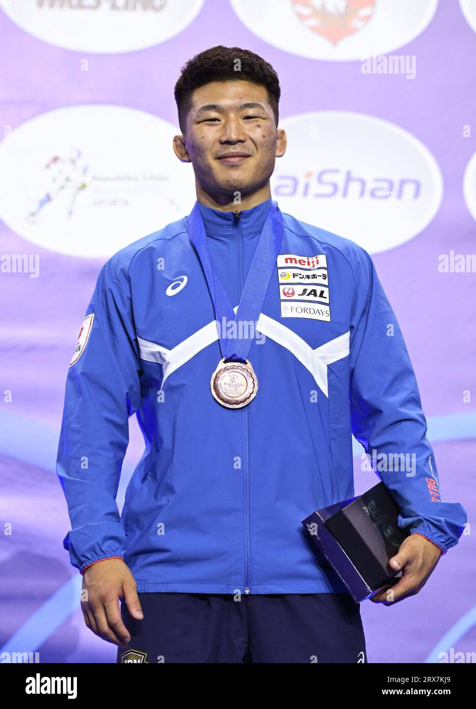 Nao Kusaka poses after winning bronze in the men's Greco-Roman 77 ...