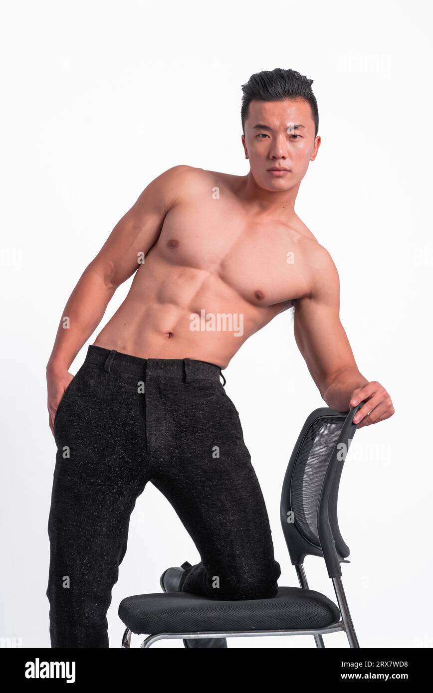 Model leaning on the chair Stock Photo - Alamy