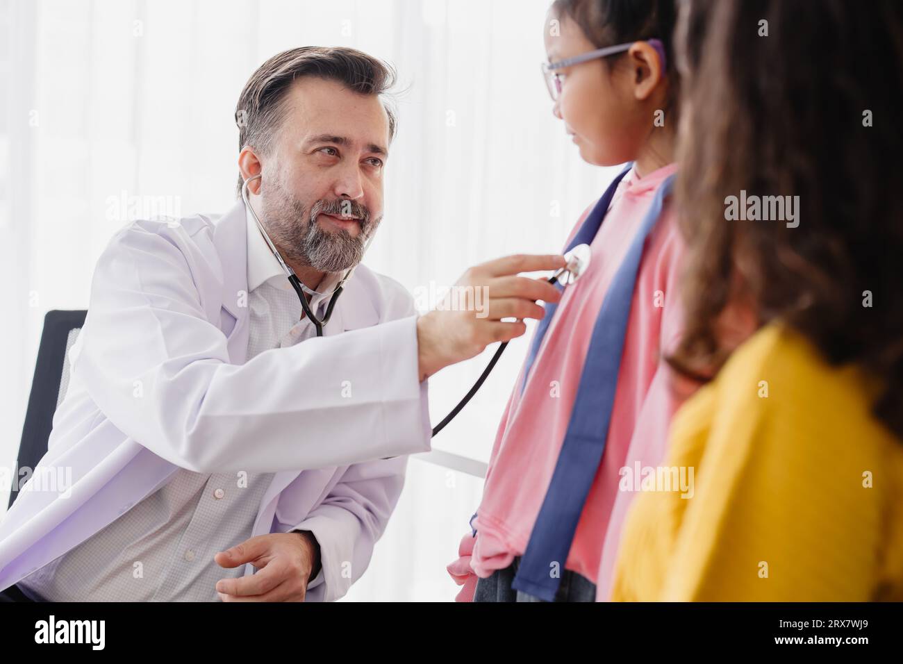 Mother with daughter meeting pediatrician doctor at the clinic for ...
