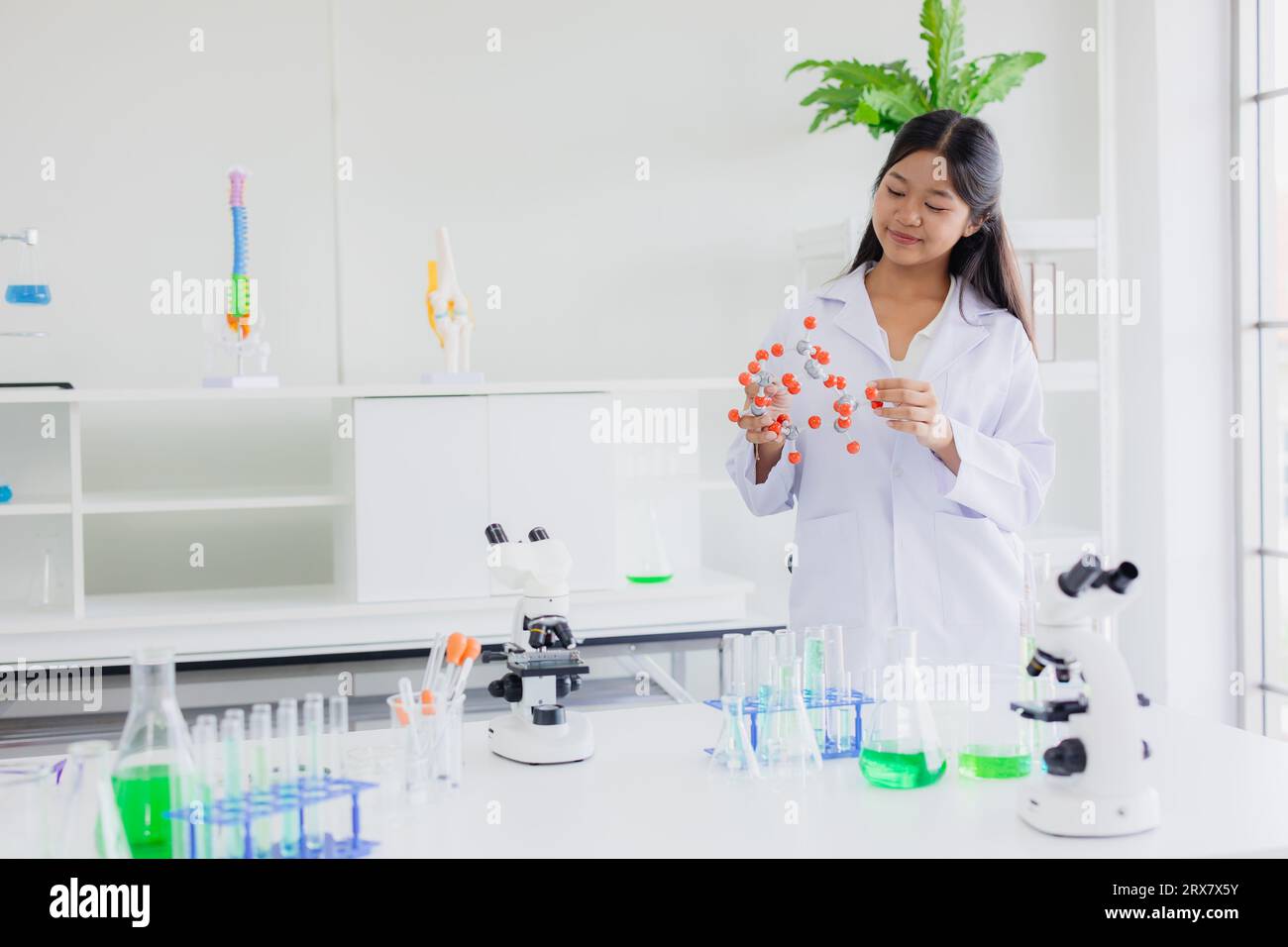 Portrait smart young asian teen scientist girl on white coat role ...