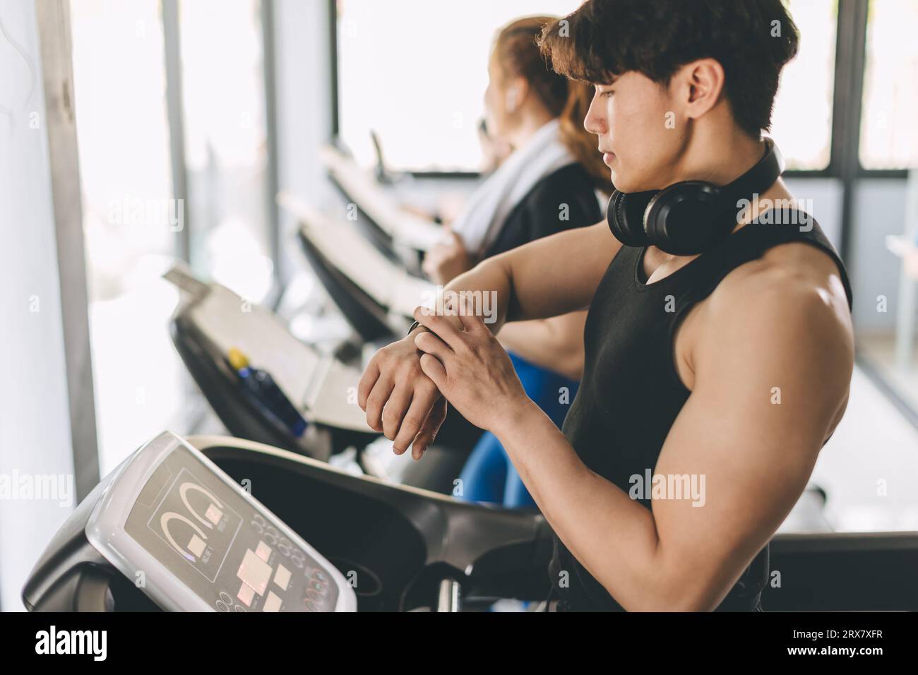 People running on a treadmill in health club using Smart Watch tracking ... People running on a treadmill in health club using Smart Watch tracking ...