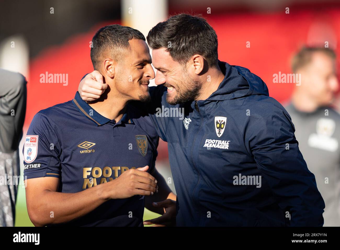 Johnnie Jackson, manager of AFC Wimbledon (R) and Ali Al-Hamadi of AFC ...