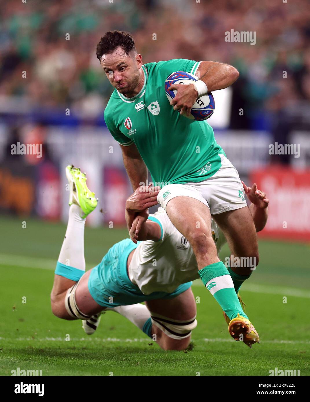 Ireland's Hugo Keenan (right) attempts to get past South Africa's ...