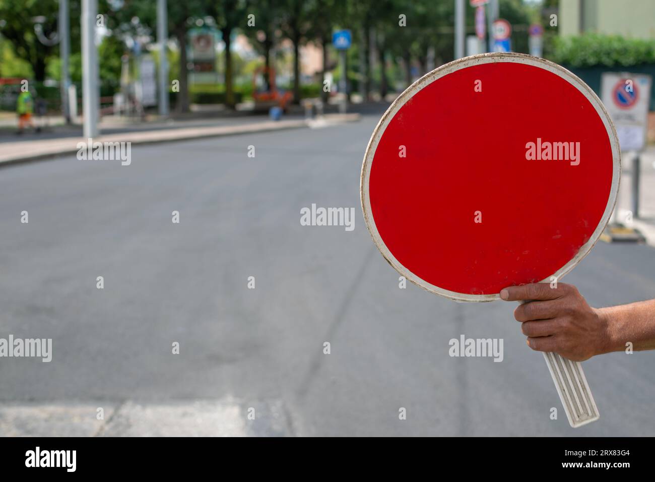 Image of Construction worker holding a Red Stop Sign and directing ...