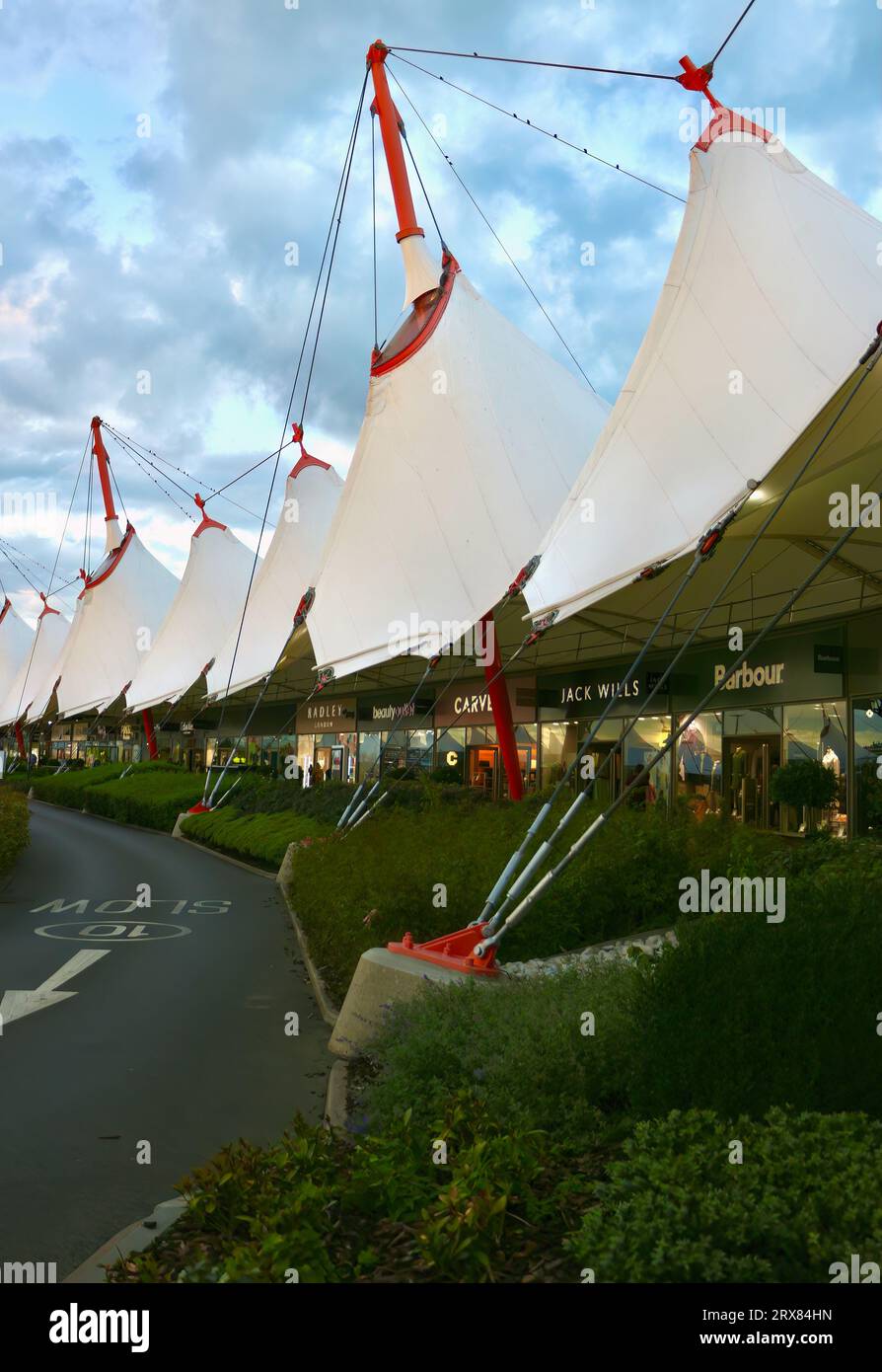 Ashford Designer Outlet shopping centre with a dramatic sky at sunset ...