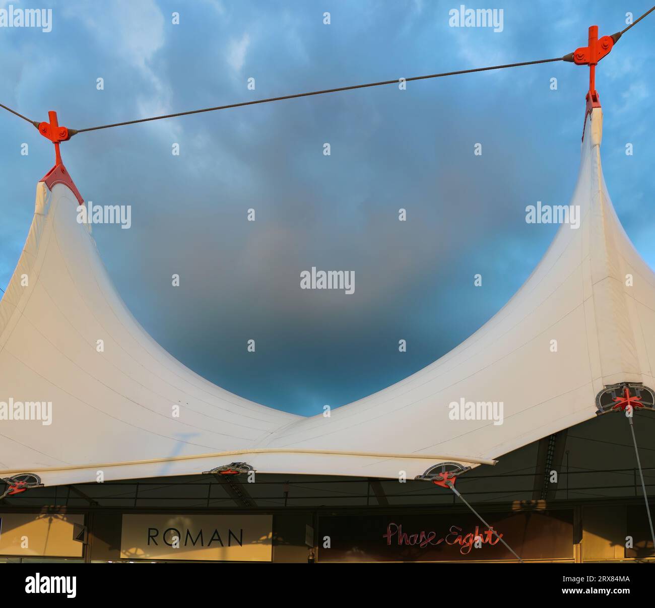 Ashford Designer Outlet shopping centre with a dramatic sky at sunset ...