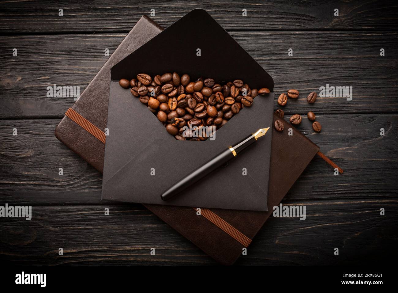 Coffee beans on a kraft paper envelope. Black background. High quality ...