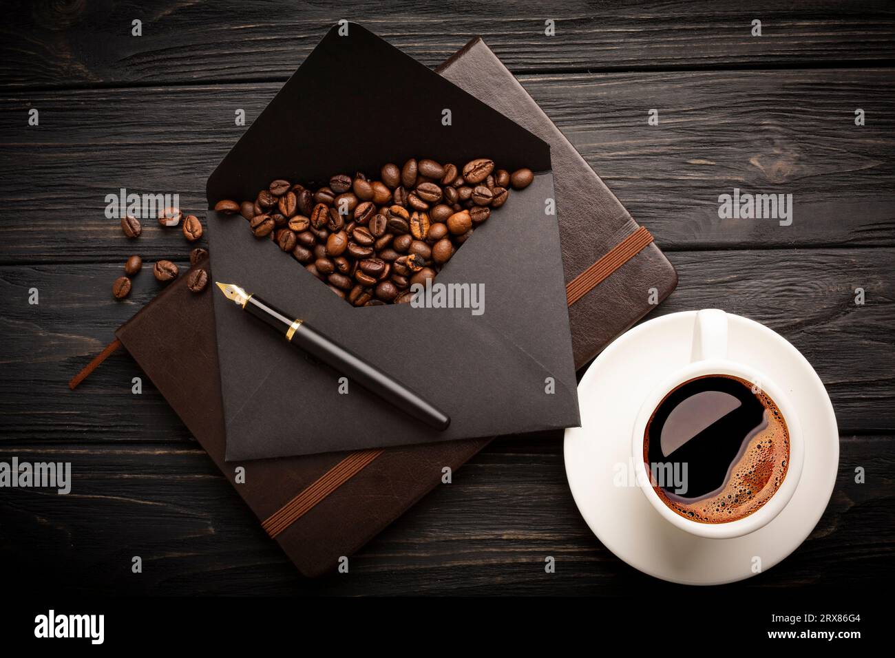 Coffee beans on a kraft paper envelope. Black background. High quality ...