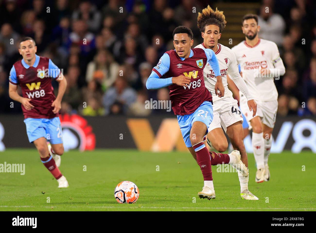 Aaron Ramsey #21 of Burnley runs past Hannibal Mejbri #46 of Manchester ...
