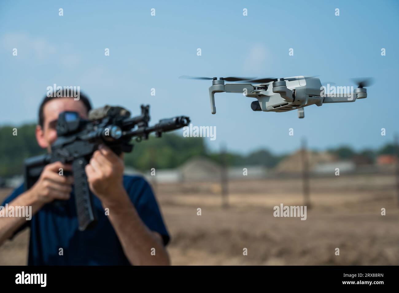 Man aiming to shoot a rifle at a flying drone outdoors Stock Photo - Alamy