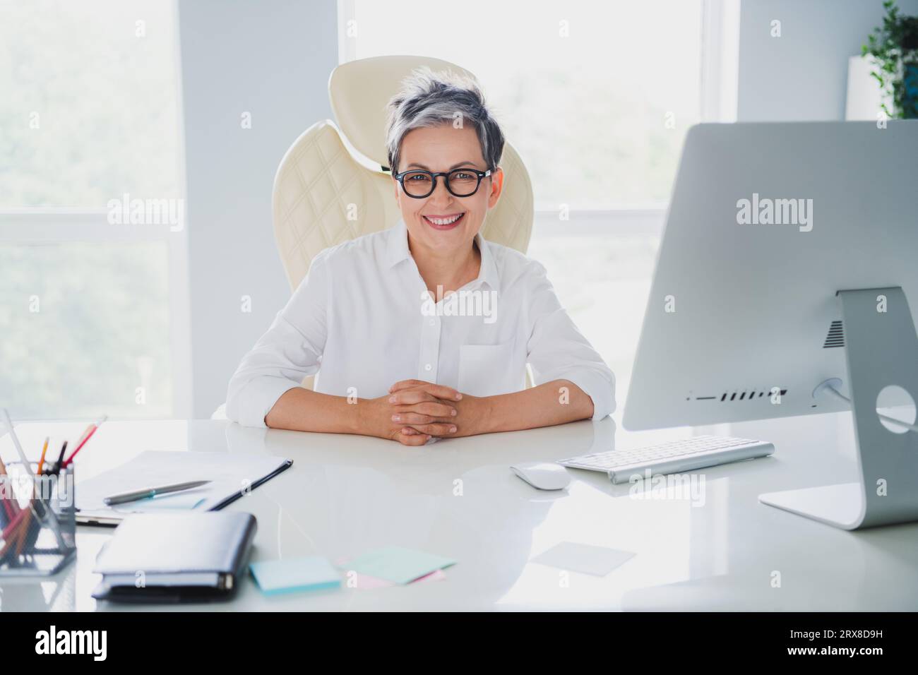 Photo of sweet charming lady assistant wear white shirt texting emails ...