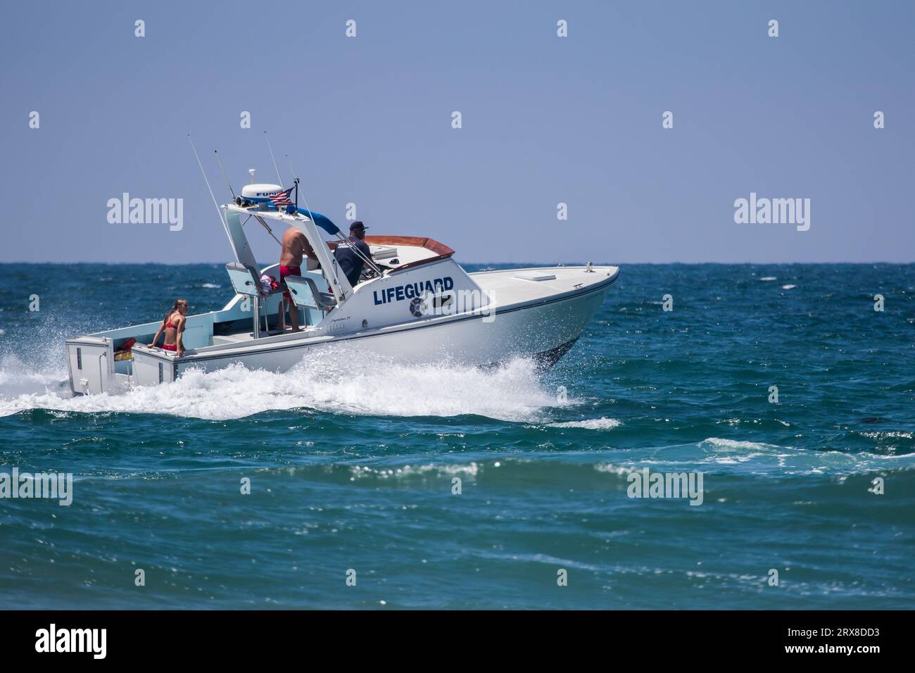 White Lifeguard boat and crew patrolling the waters off Newport Beach ...