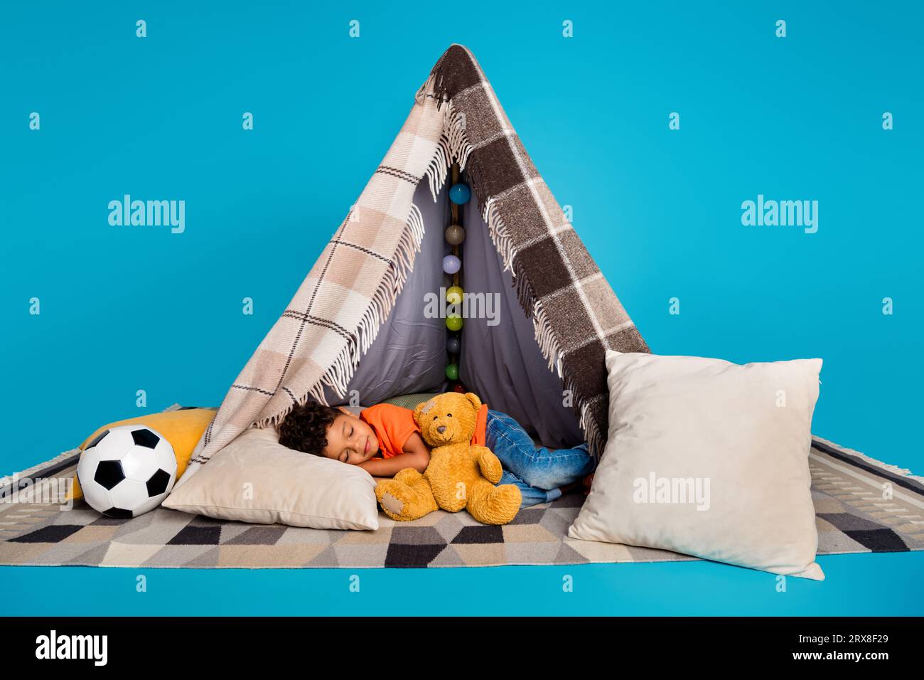 Photo of little cute boy playing in homemade tent sleeping nap isolated ...