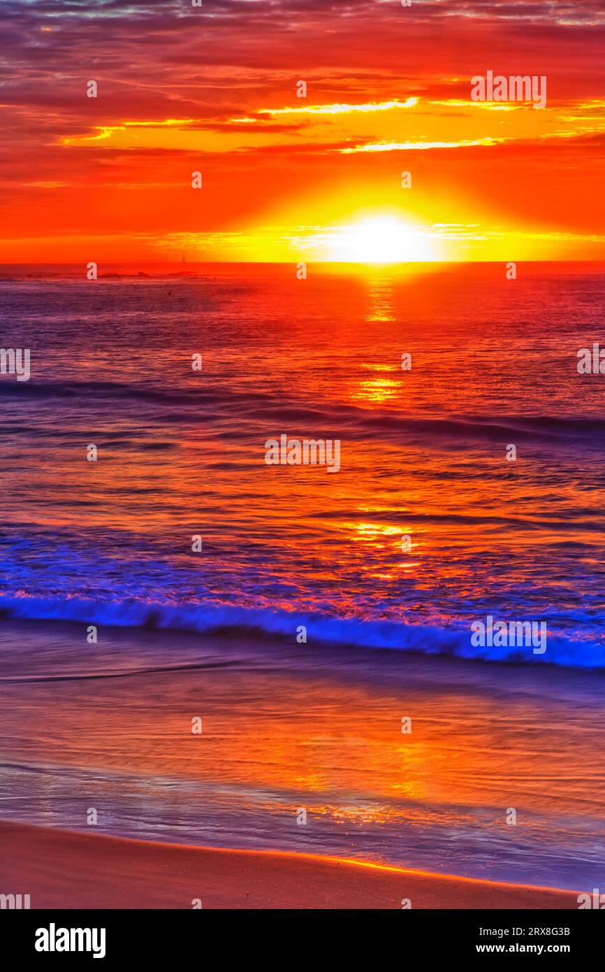 Colourful bright sunrise over Pacific ocean horizon off Nobbys head ...