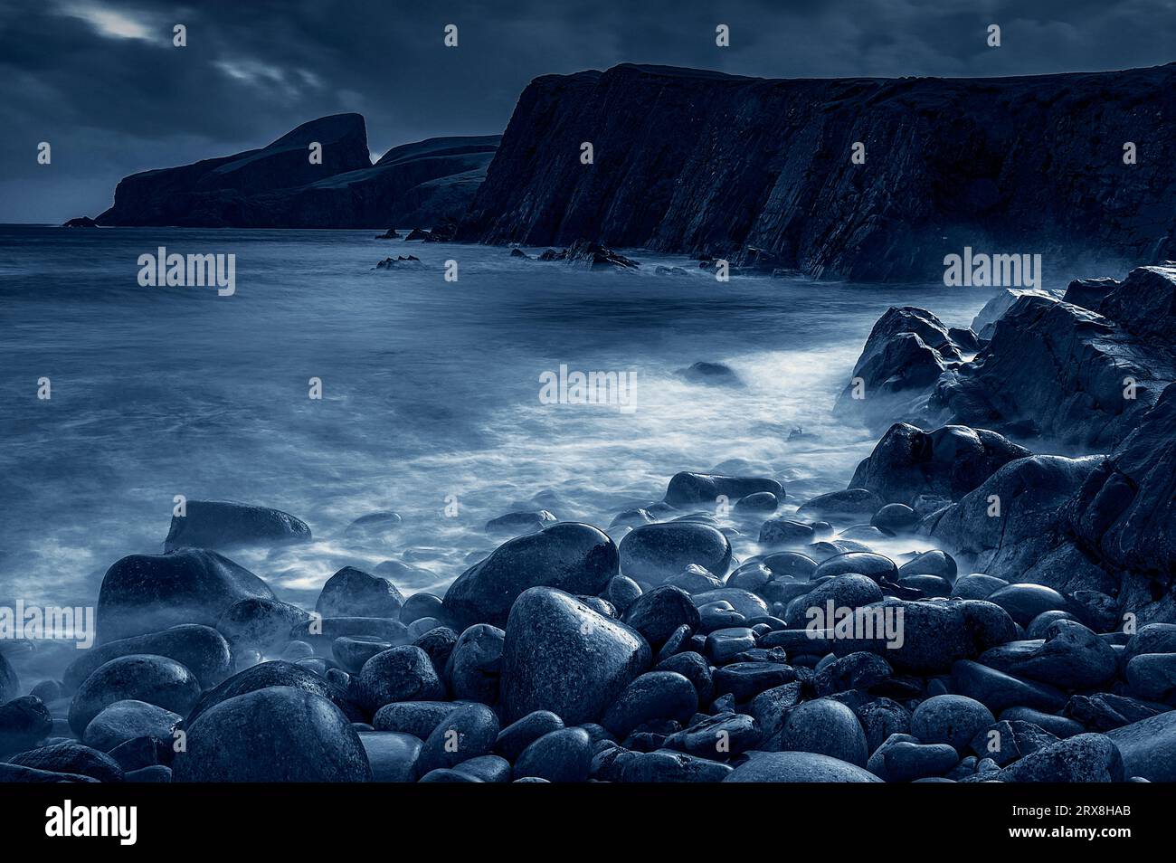 The dramatic boulder strewn shore of North Haven, Fair Isle, Shetland ...