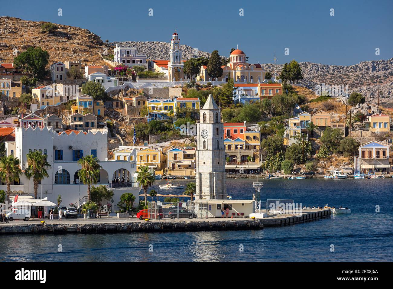 Sunny View of Ano Symi with Annunciation Church and Clocktower ...