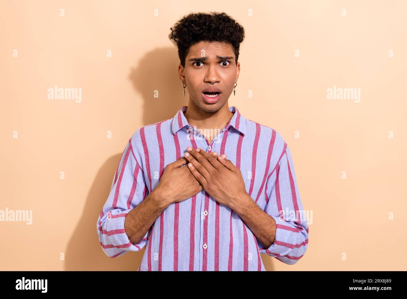 Portrait of speechless guy with piercing dressed stylish shirt hold ...