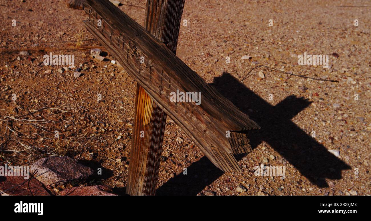 Creeping shadow of a wooden grave cross crawls across the natural ...