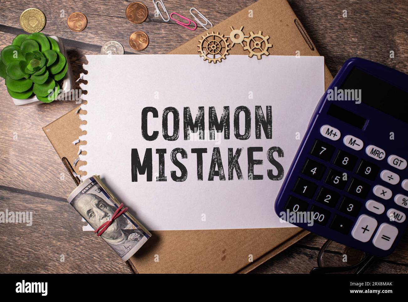 On a light background, a white notebook with the text COMMON MISTAKES ...