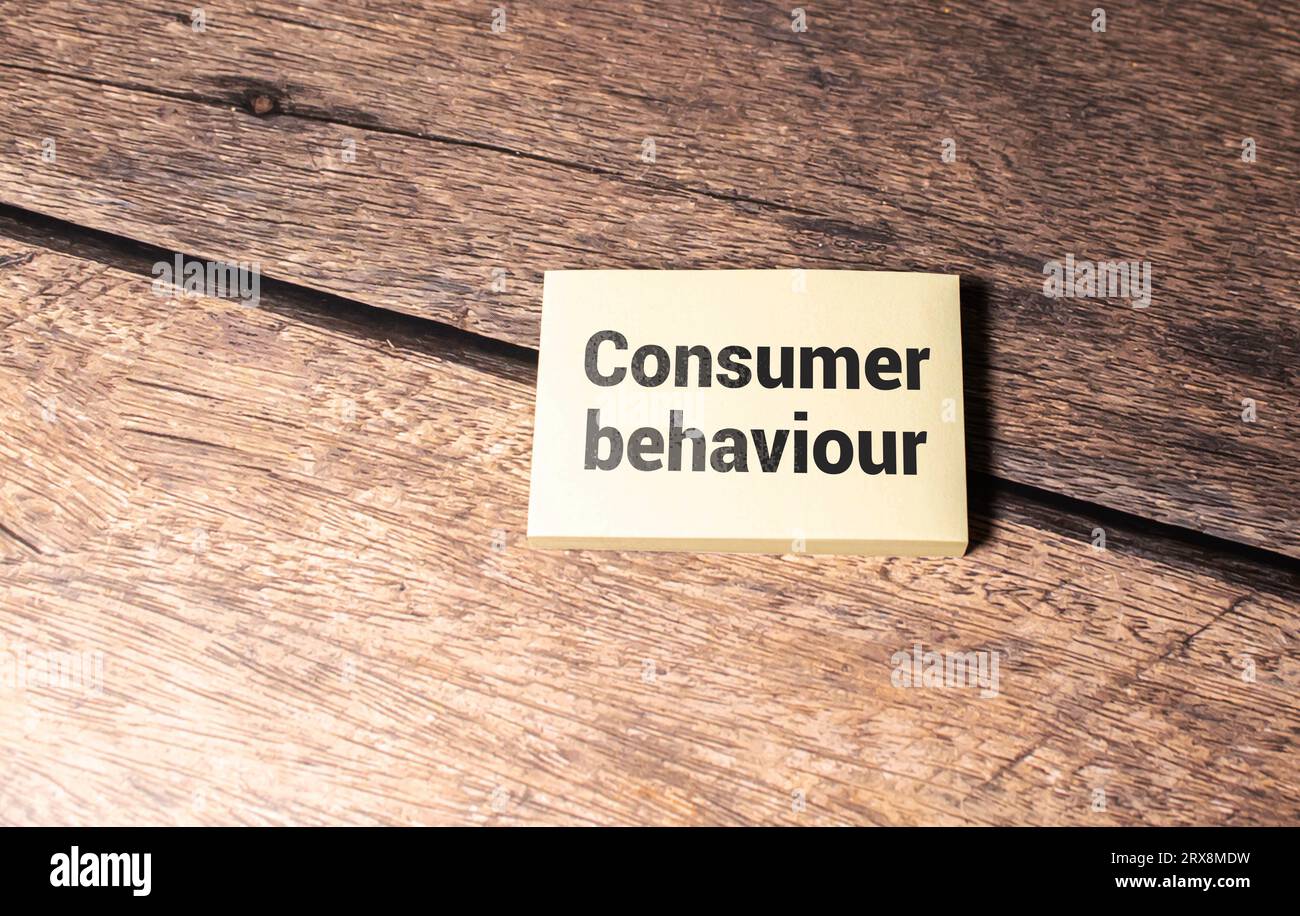 mini black board with text consumer behaviour isolated on wooden ...
