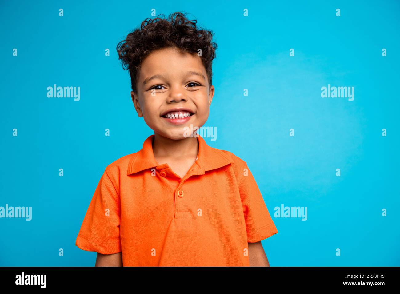 Portrait of sweet positive kid boy looking in camera toothy smiling ...