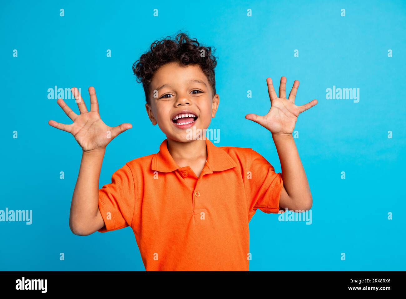 Photo of positive boy showing hands ten fingers isolated over blue ...