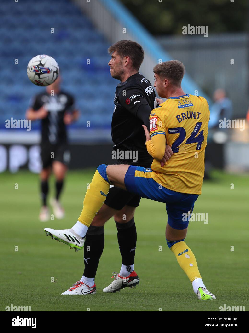 Lewis Brunt of Mansfield Town in action with Barrow's Jamie Proctor ...