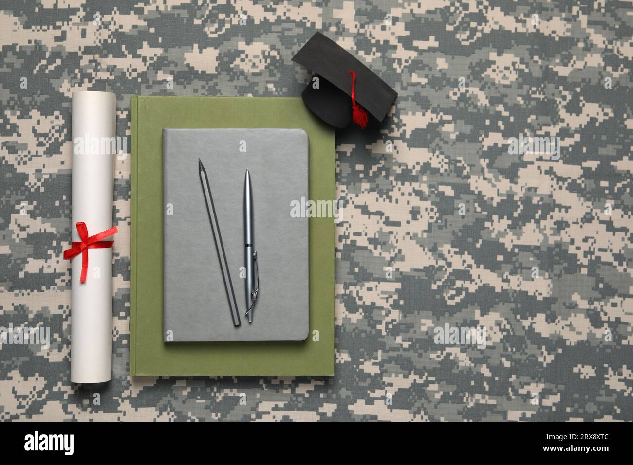 Stationery, diploma and mortarboard on camouflage background, flat lay ...
