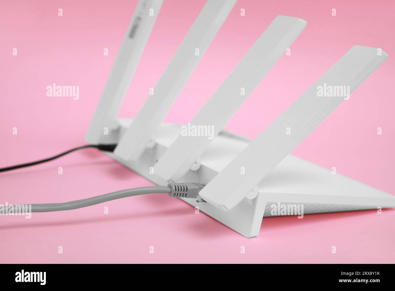 Modern Wi-Fi router on pink background, closeup Stock Photo - Alamy