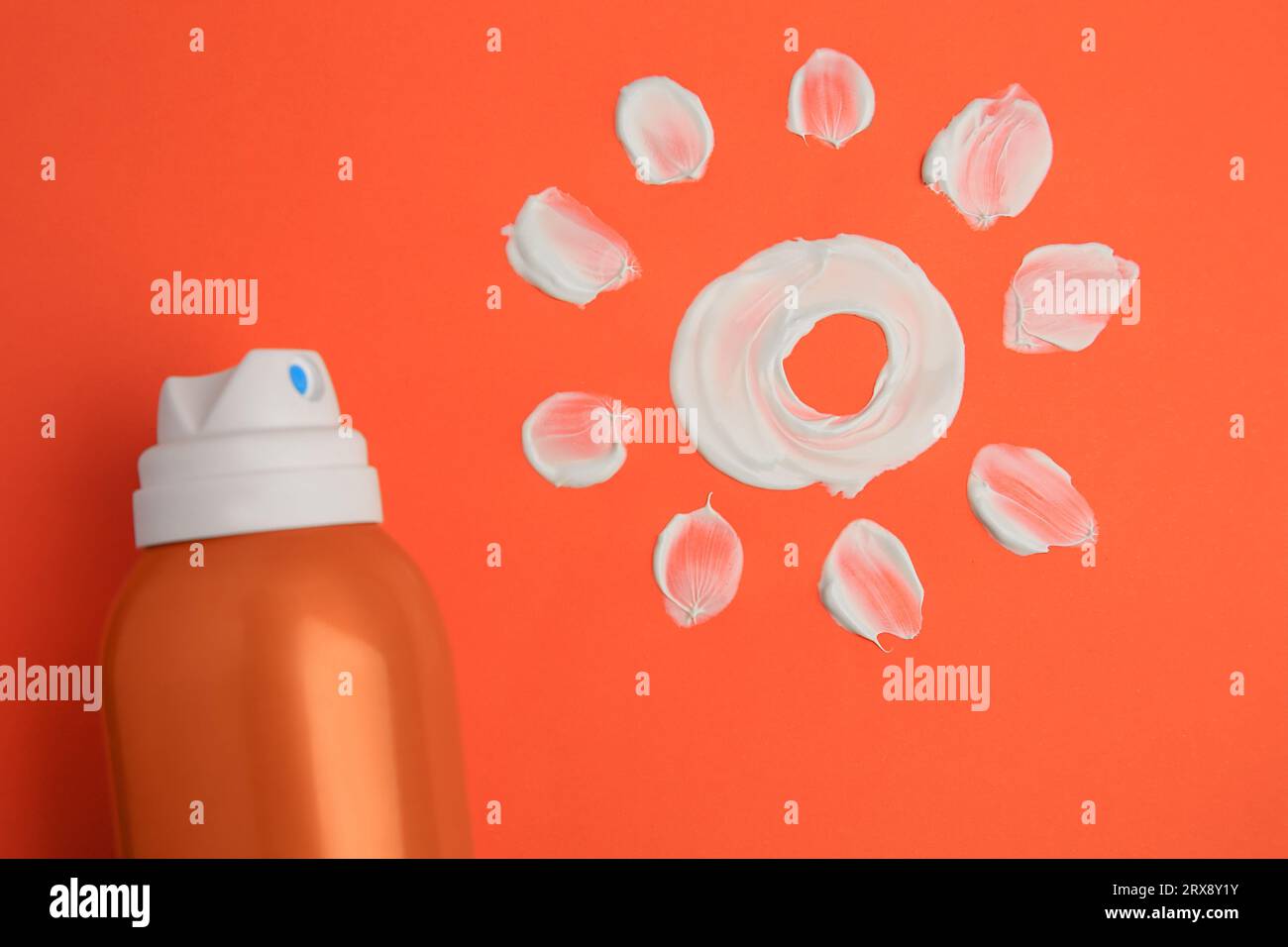 Drawing of sun and bottle with sunscreen on coral background, top view ...