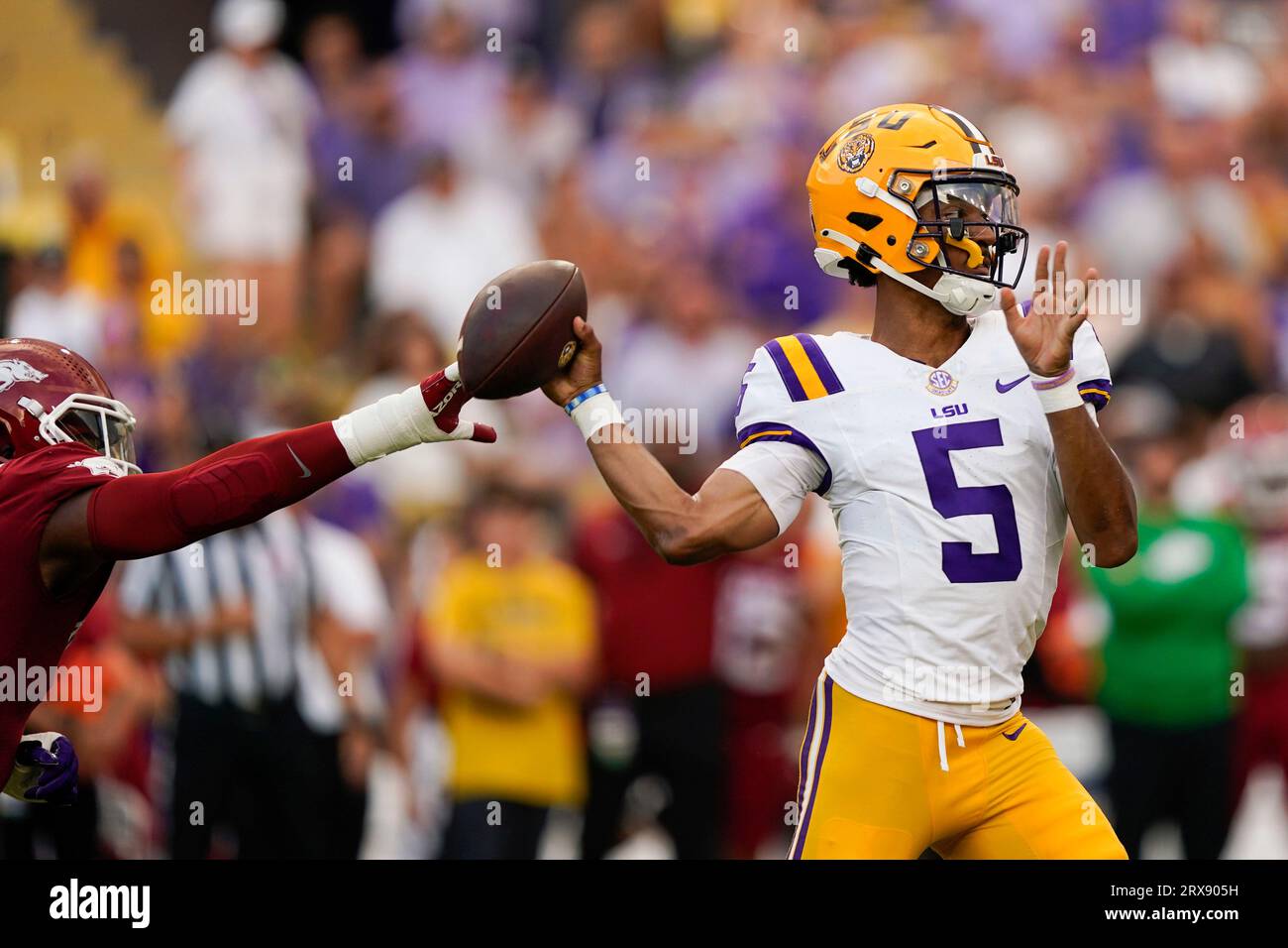 LSU quarterback Jayden Daniels (5) passes under pressure in the first half of an NCAA college ...