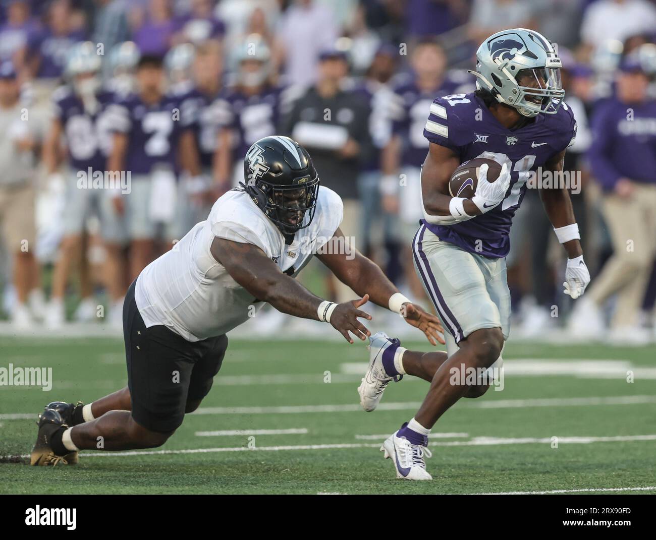 Kansas State running back DJ Giddens, right, breaks the tackle of ...