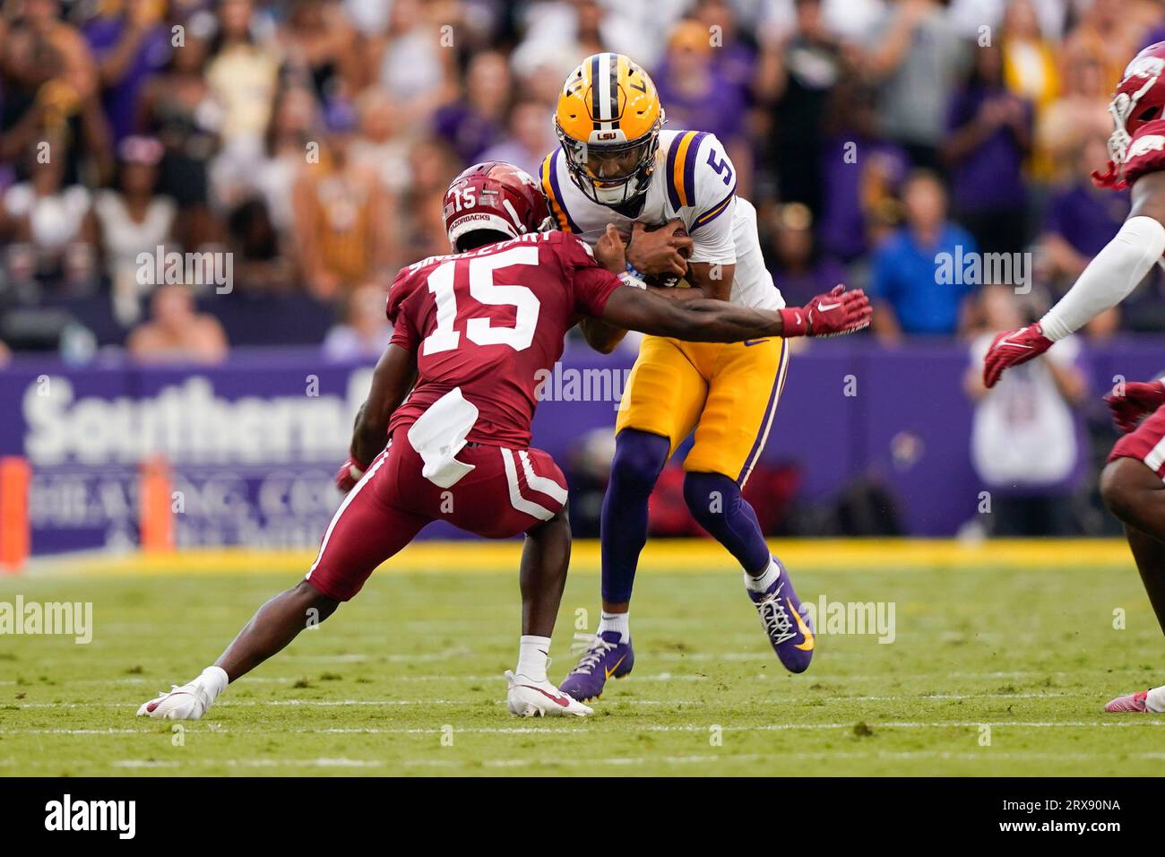 LSU quarterback Jayden Daniels (5) carries against Arkansas defensive ...