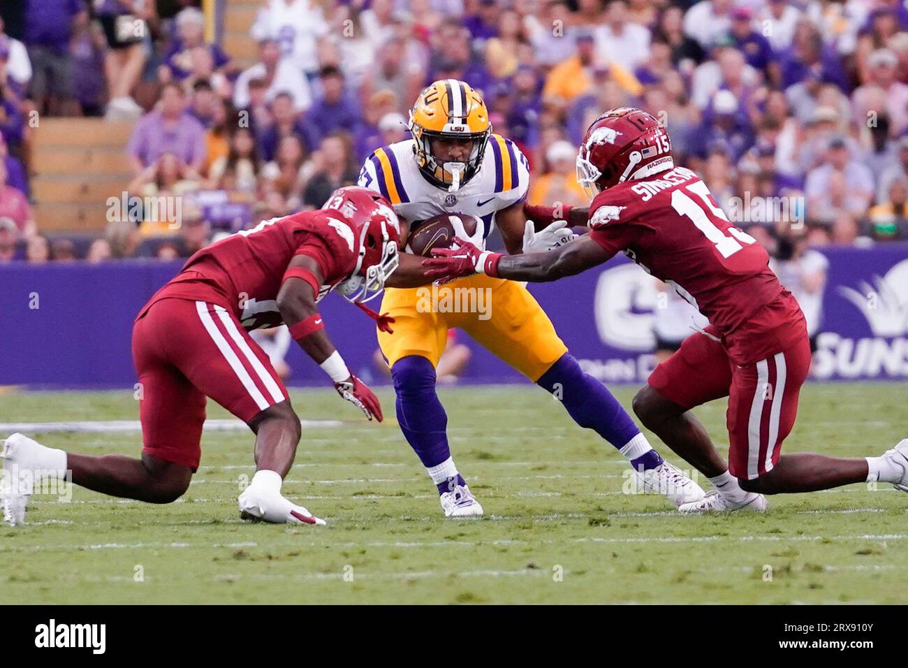 LSU running back Josh Williams (27) carries between Arkansas defensive ...