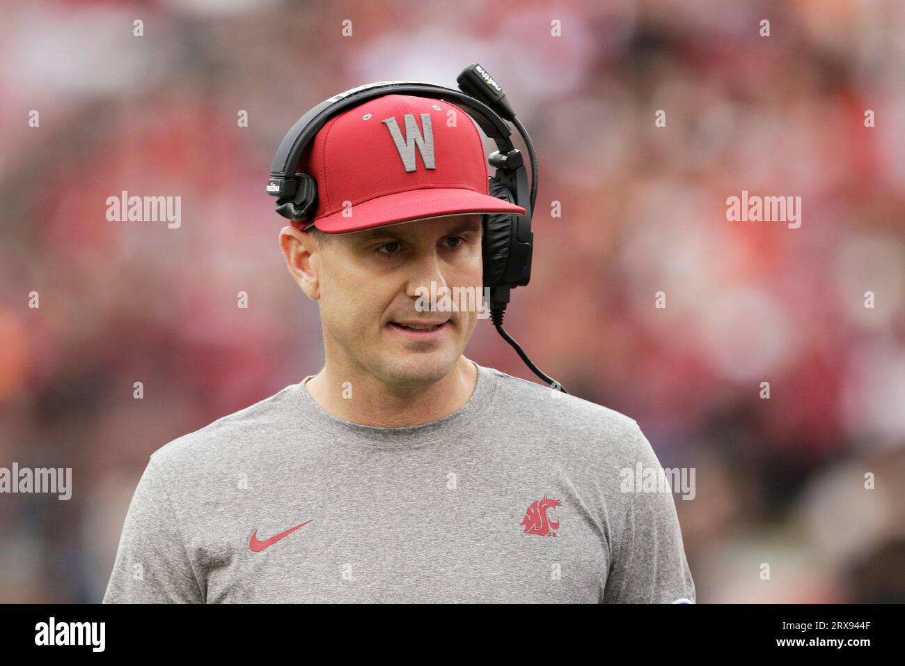 Washington State head coach Jake Dickert walks on the field during a ...