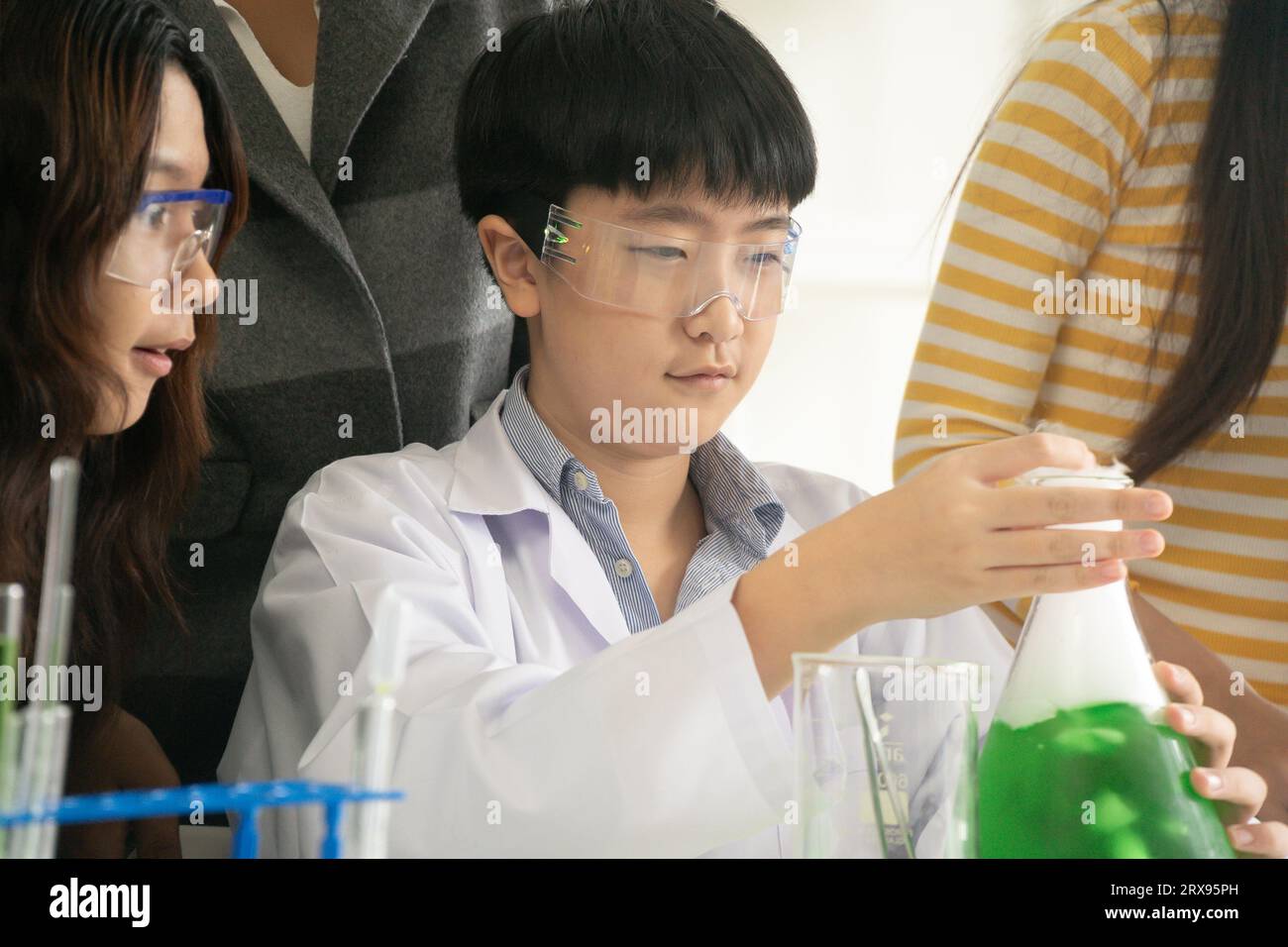 STEM education concept. Asian children in laboratory research an ...