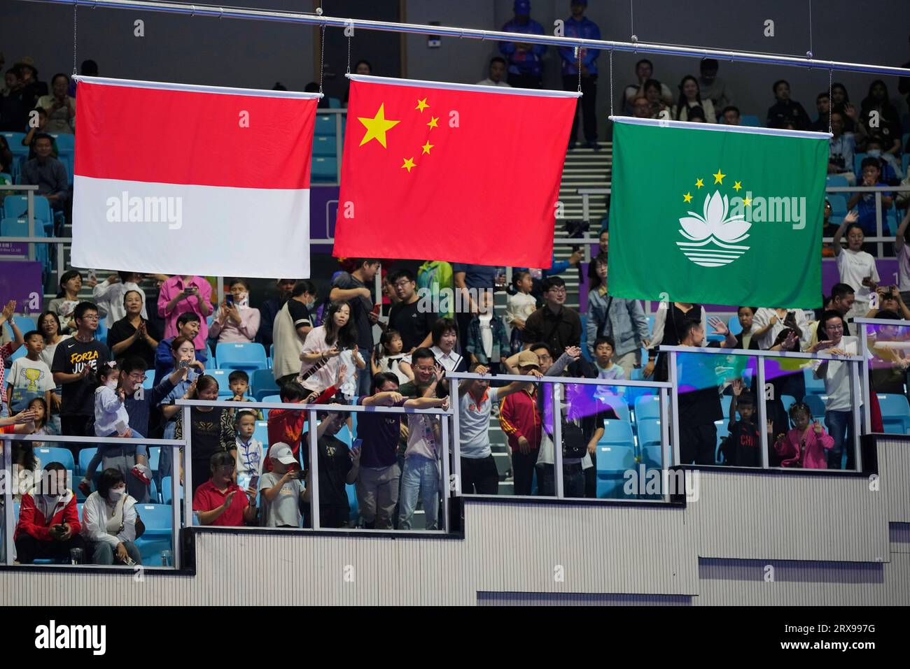National flags of China for gold, center, Indonesia for silver, left, and Macau for bronze are ...
