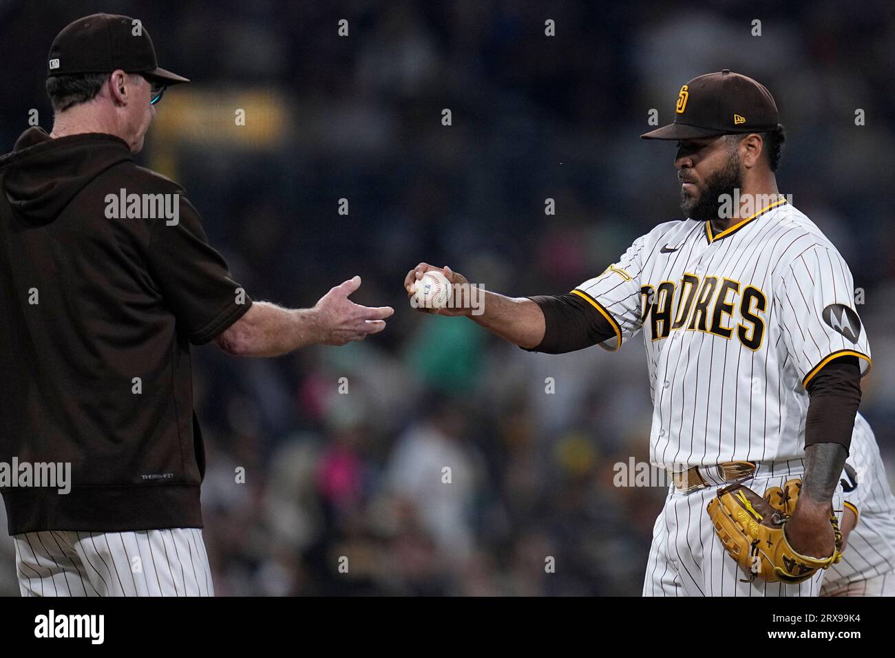 San Diego Padres relief pitcher Pedro Avila, right, hands the ball to ...