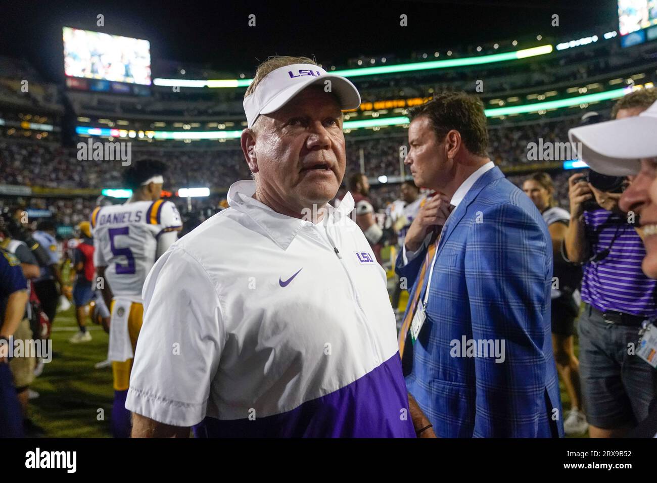LSU head coach Brian Kelly walks on the field after an NCAA college ...