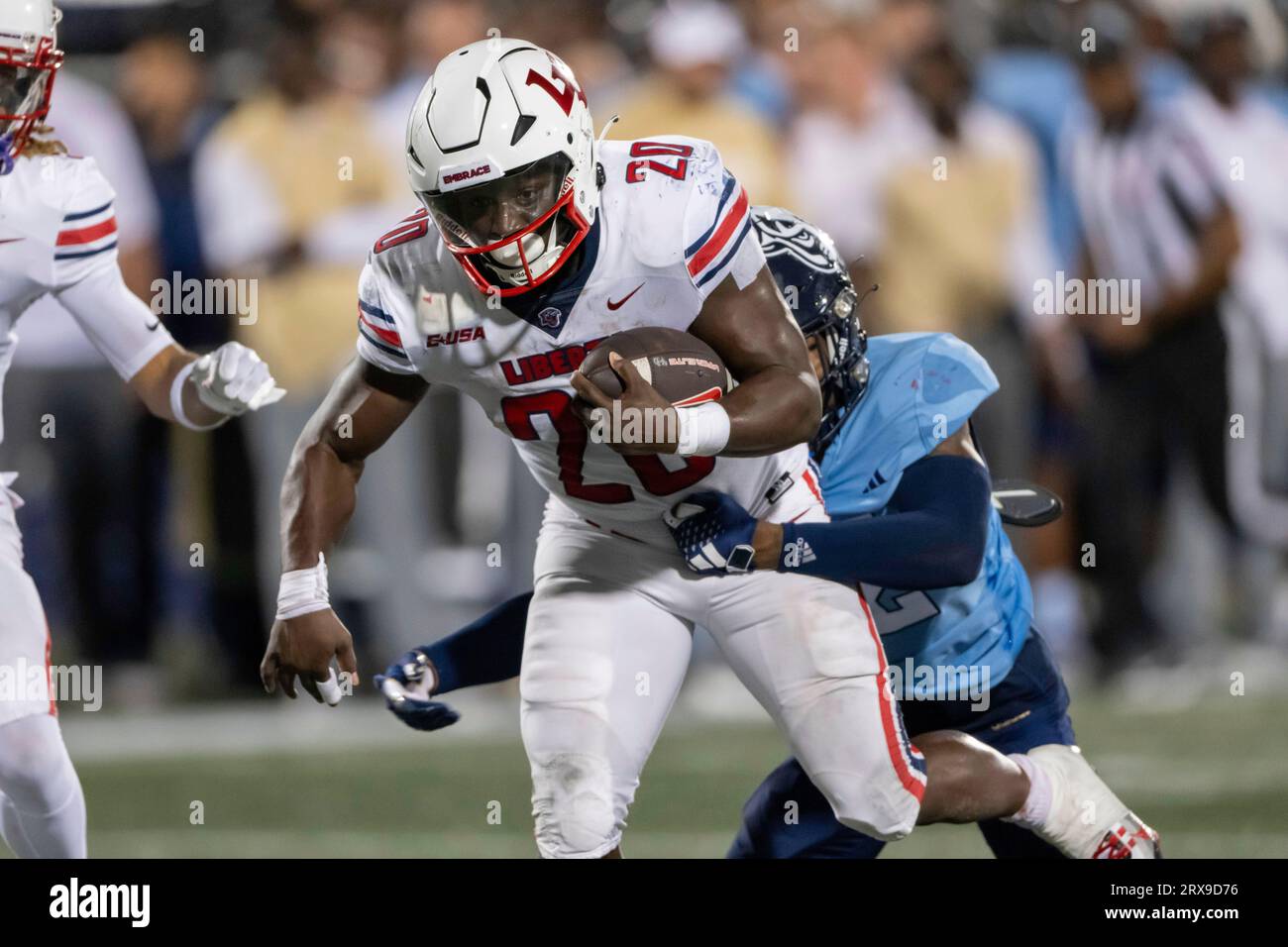 Liberty running back Quinton Cooley (20) runs with the ball and is ...