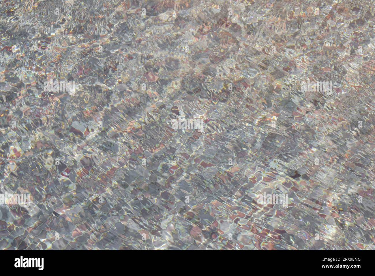 Glare on water in pool. Water surface with bizarre small waves, full ...