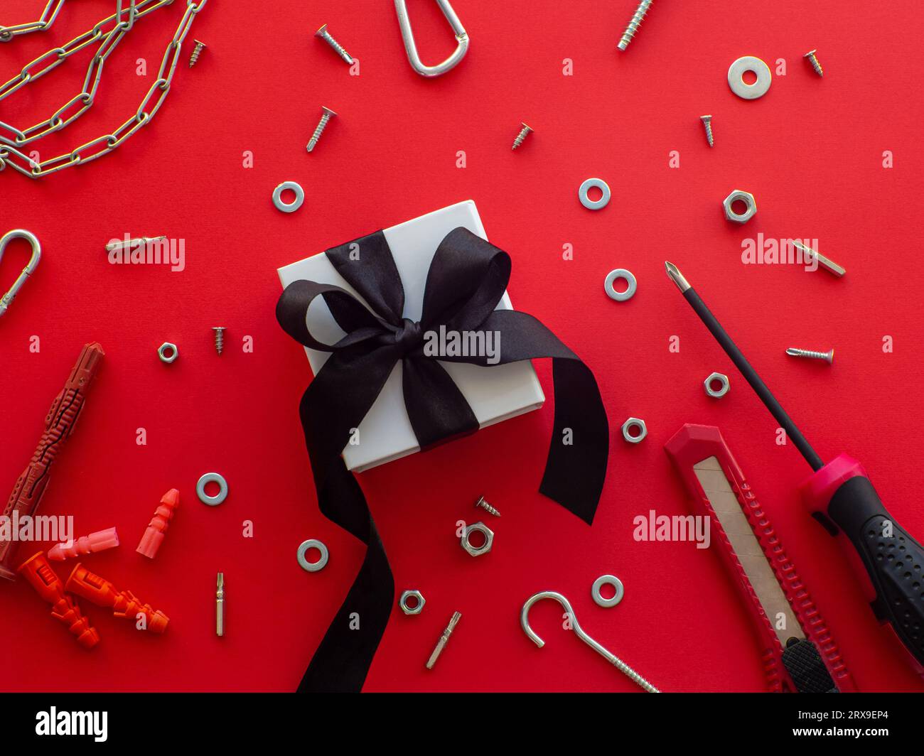 Construction tools and wrapped gift on red background. Construction ...